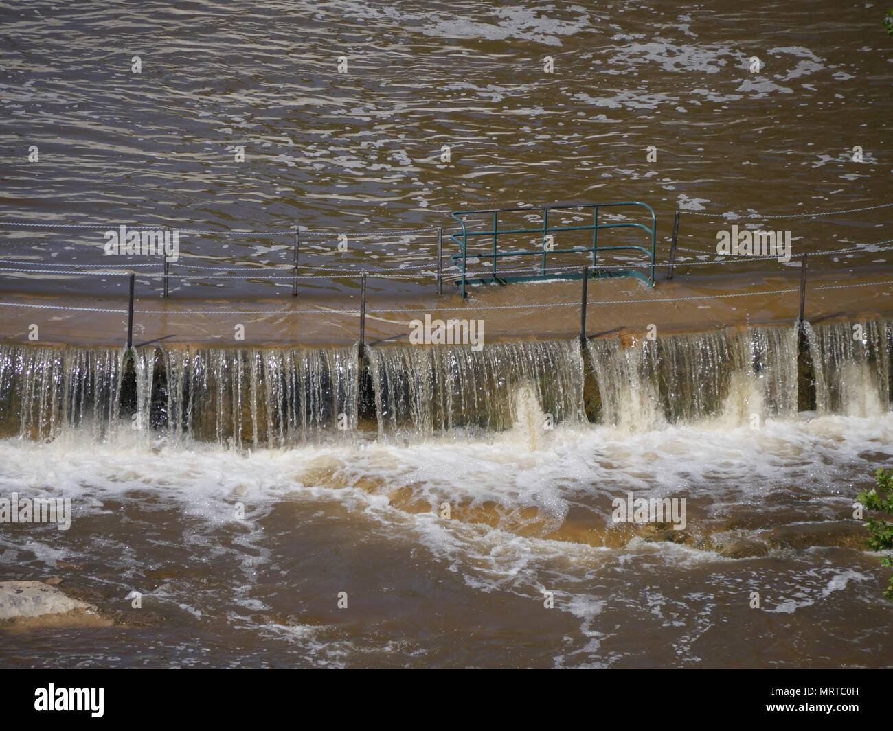 Muddy water overflows a crosswalk during a flood Stock Photo - Alamy