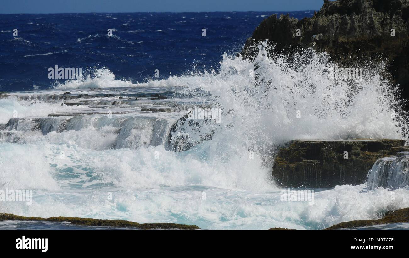 Angry waves slapping against sharp cliff rocky formations is an awesome ...