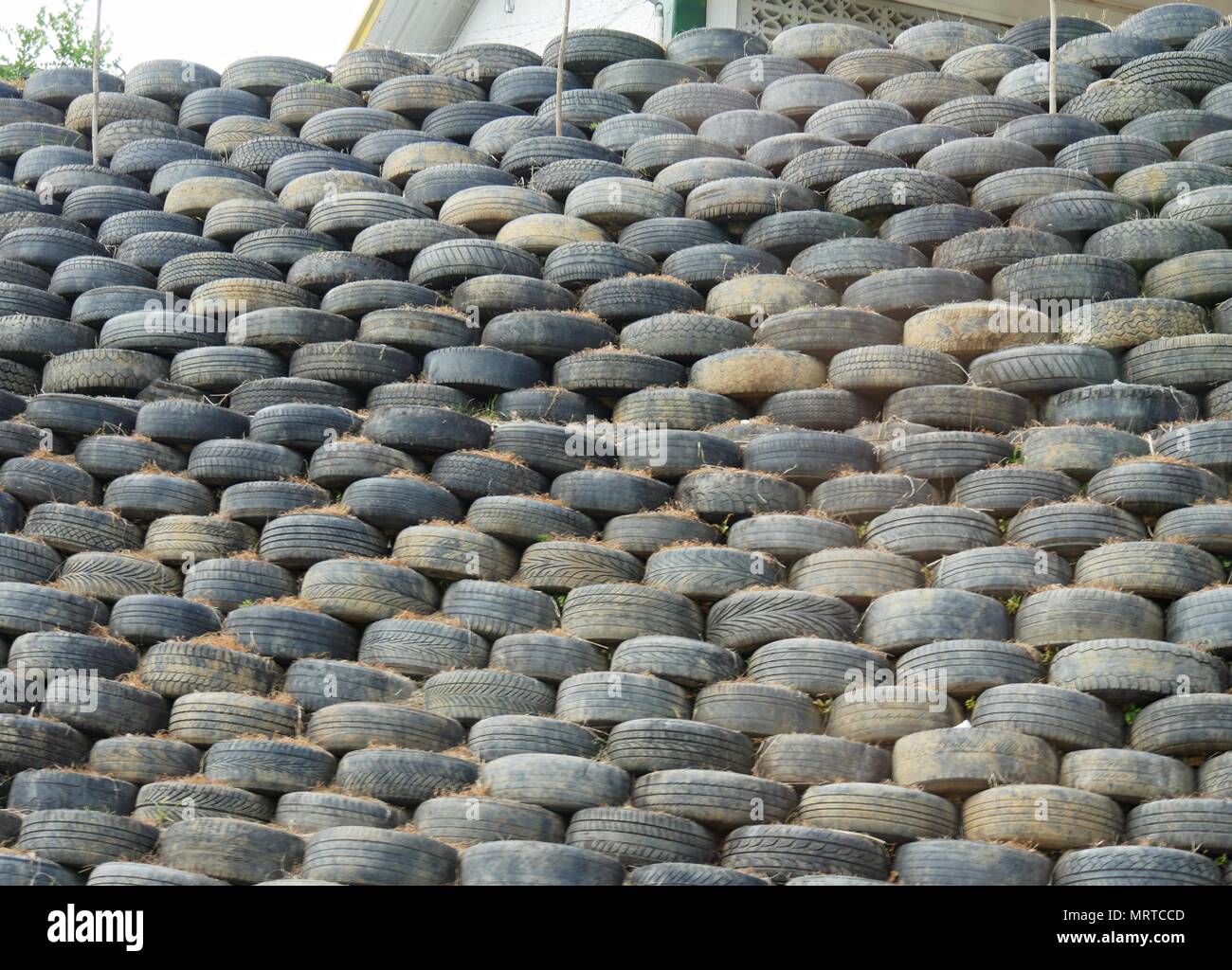 Pile of old tires meticulously piled to serve as a fence Stock Photo ...