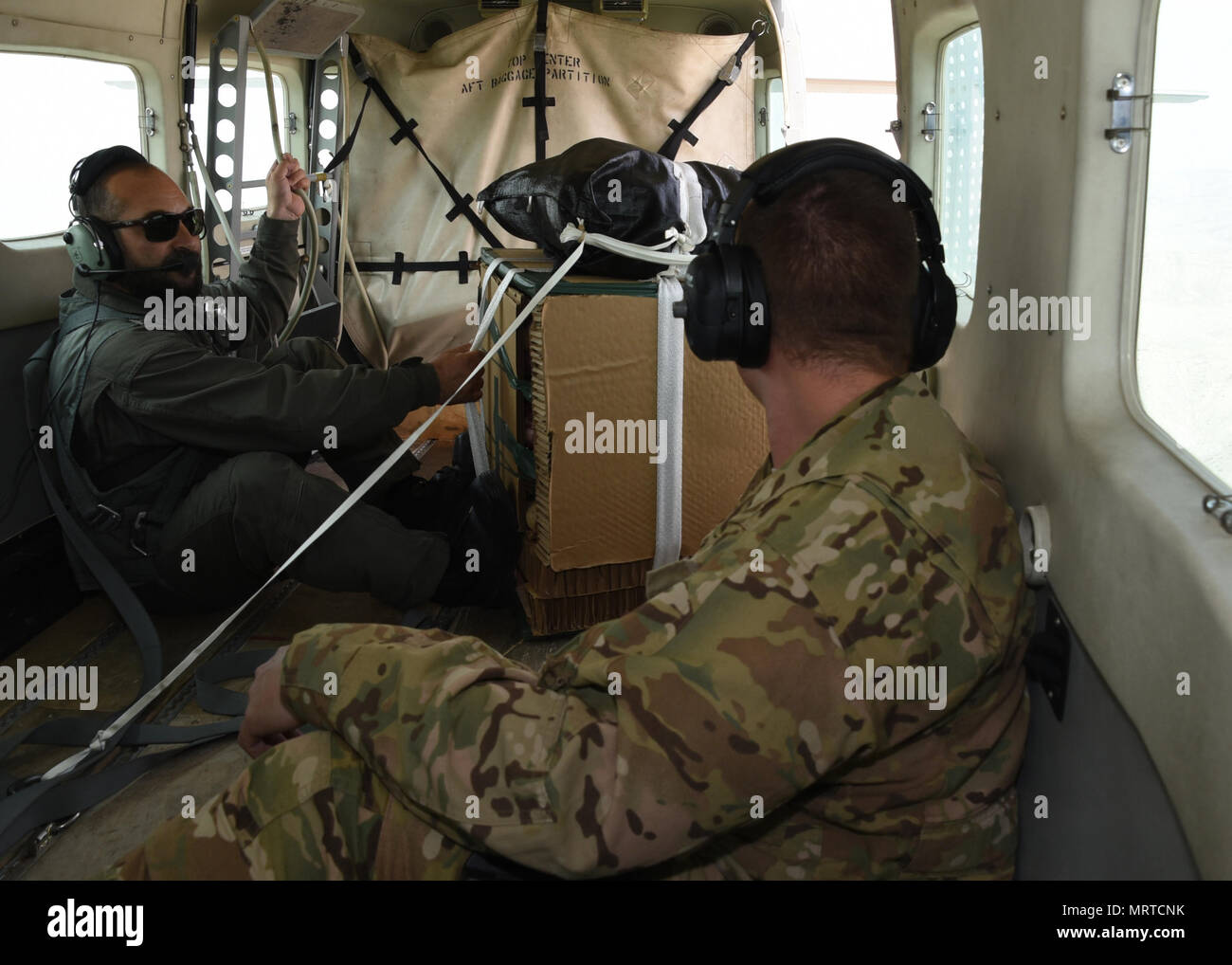 An Afghan Air Force C-208 pilot, prepares to deliver supplies, over ...