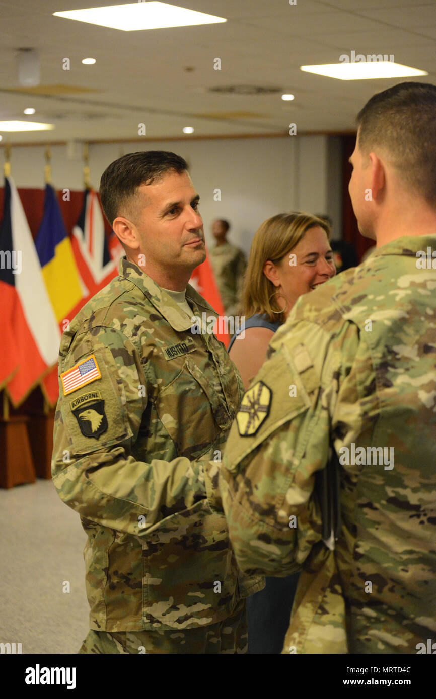 U.S. Army Col. Thomas R. Hustead (outgoing Commander), receives a ...