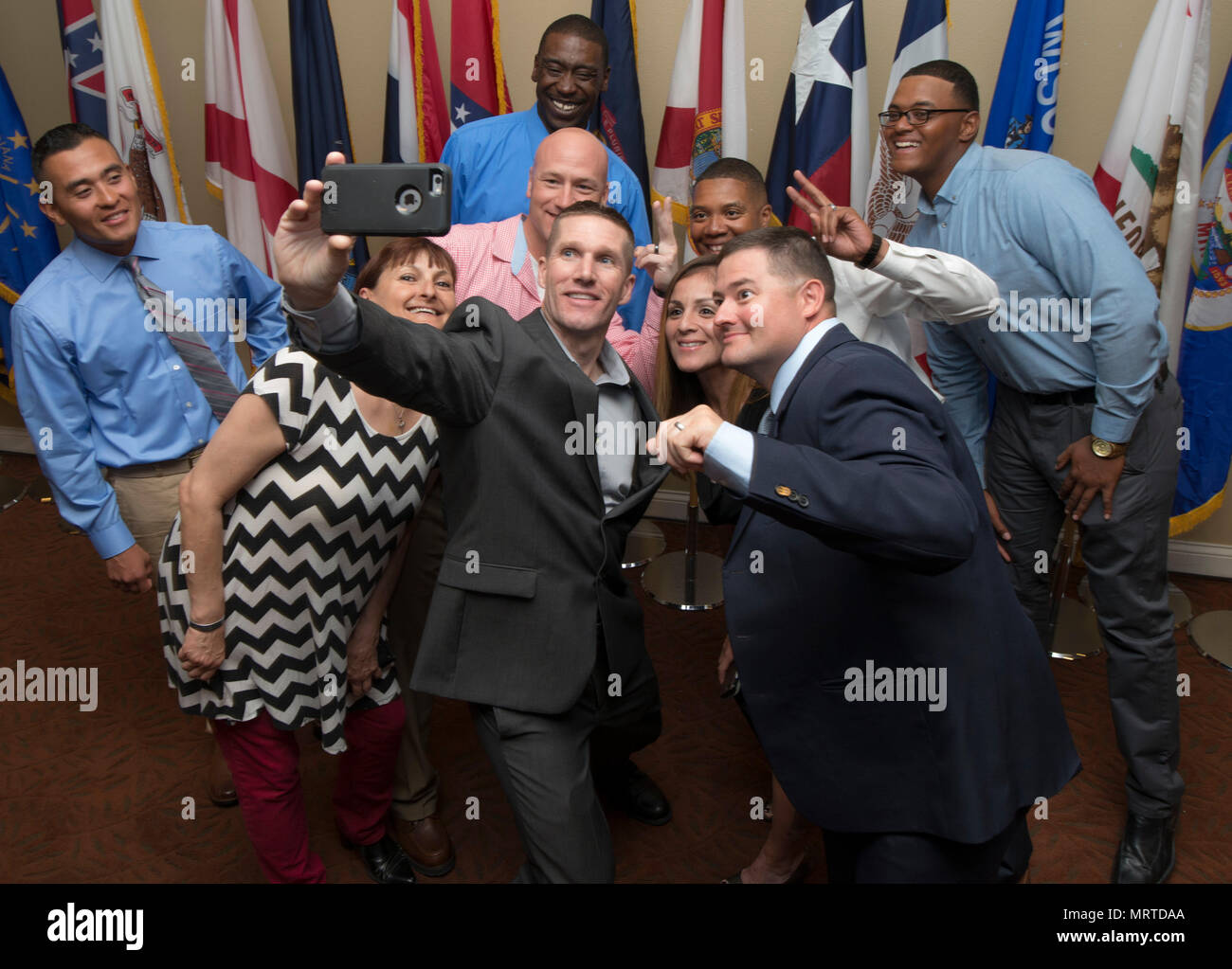 Sgt. Maj. of the Army Daniel Dailey, center, takes a selfie with a ...