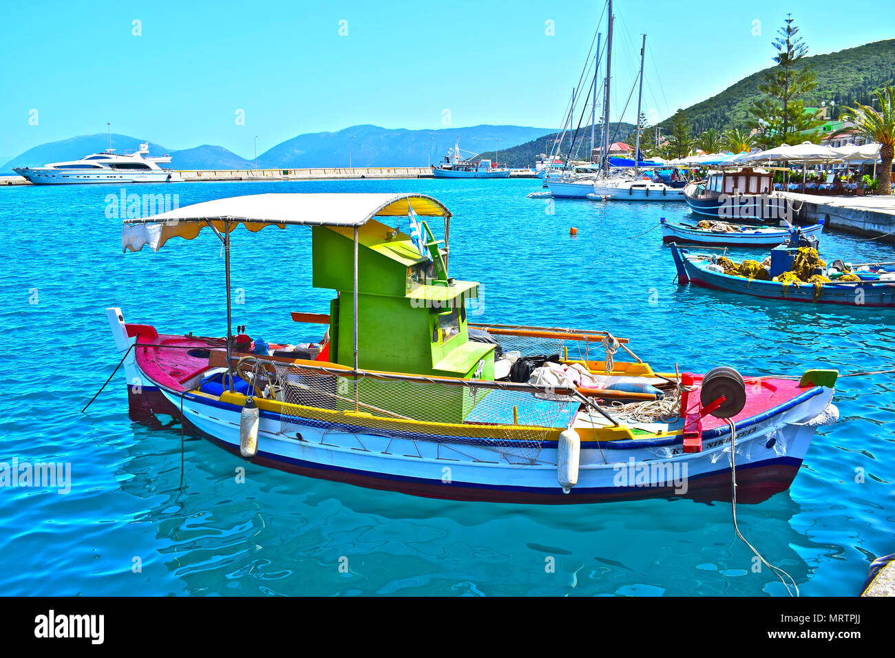 Colourful fishing boat(s) in the pretty harbour at the seaside resort ...