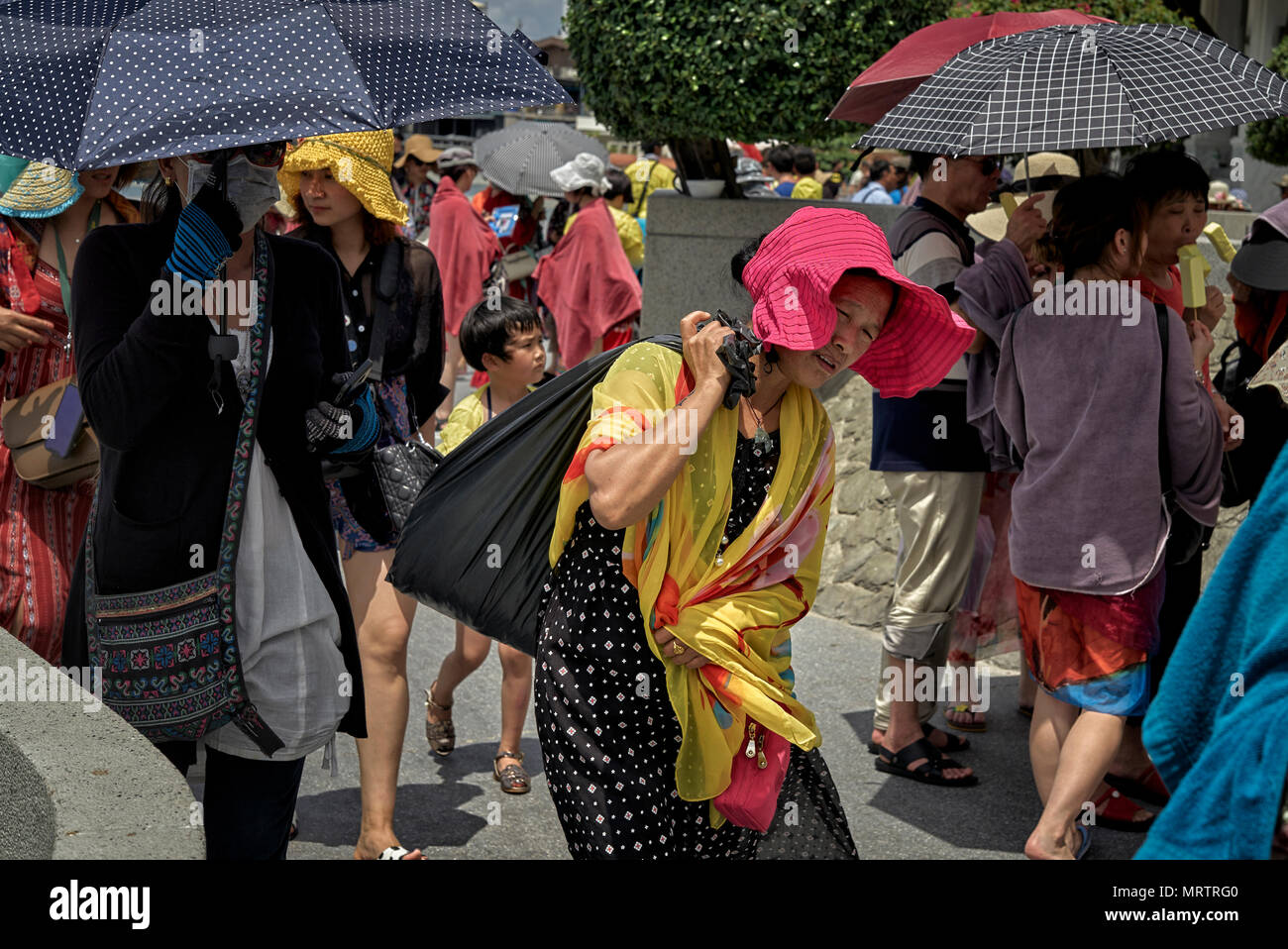 Woman distressed carrying a heavy sack and seemingly in pain Stock ...