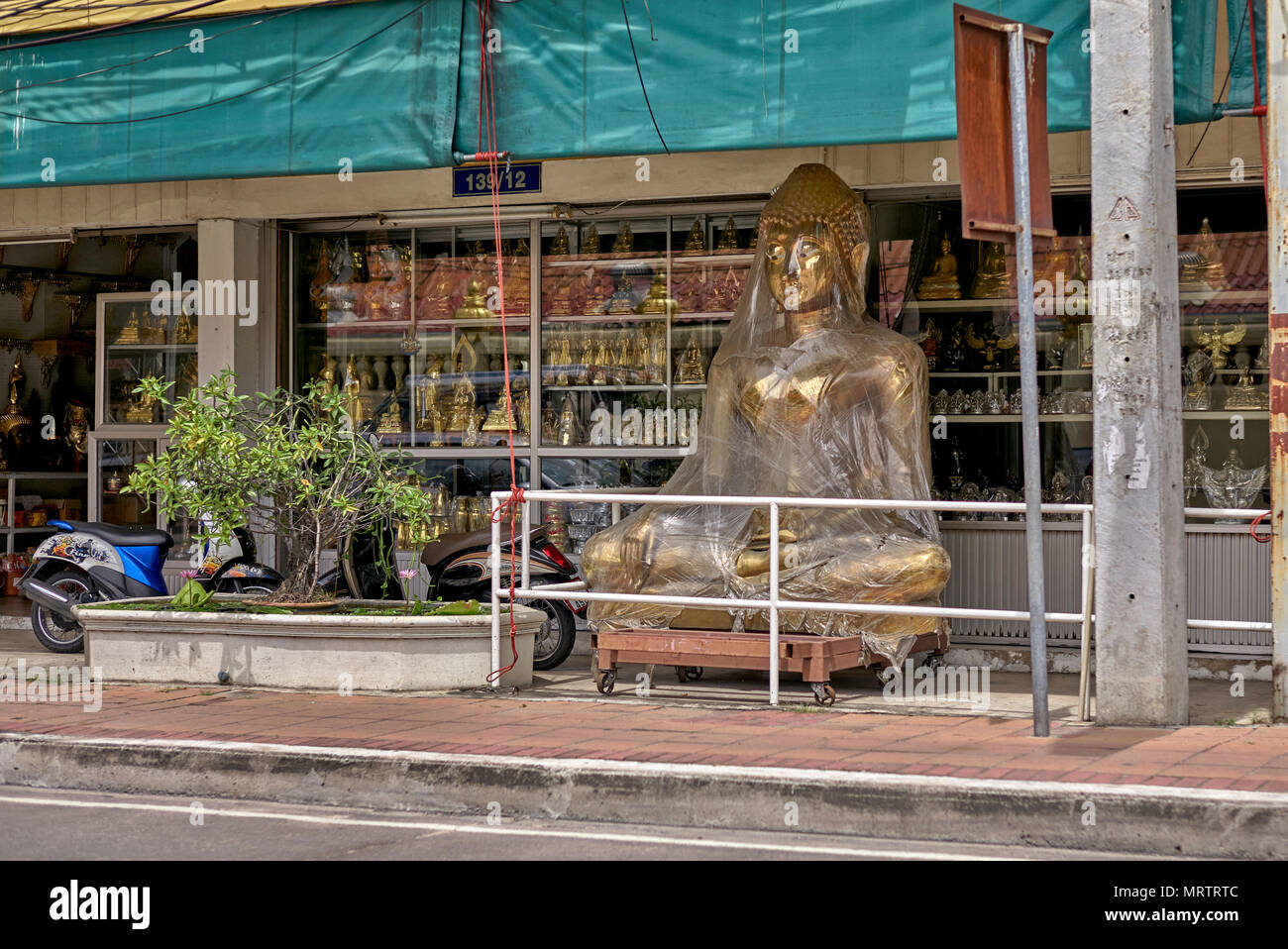 Plastic wrapped buddha statue hi-res stock photography and images - Alamy