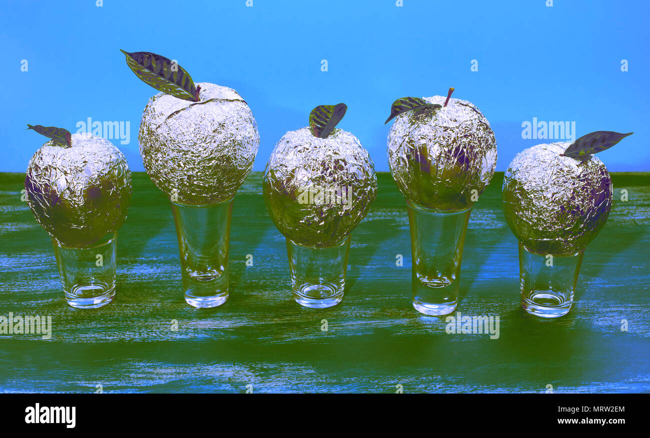 Surrealism Five apples in the shell foil with natural green leaves ...
