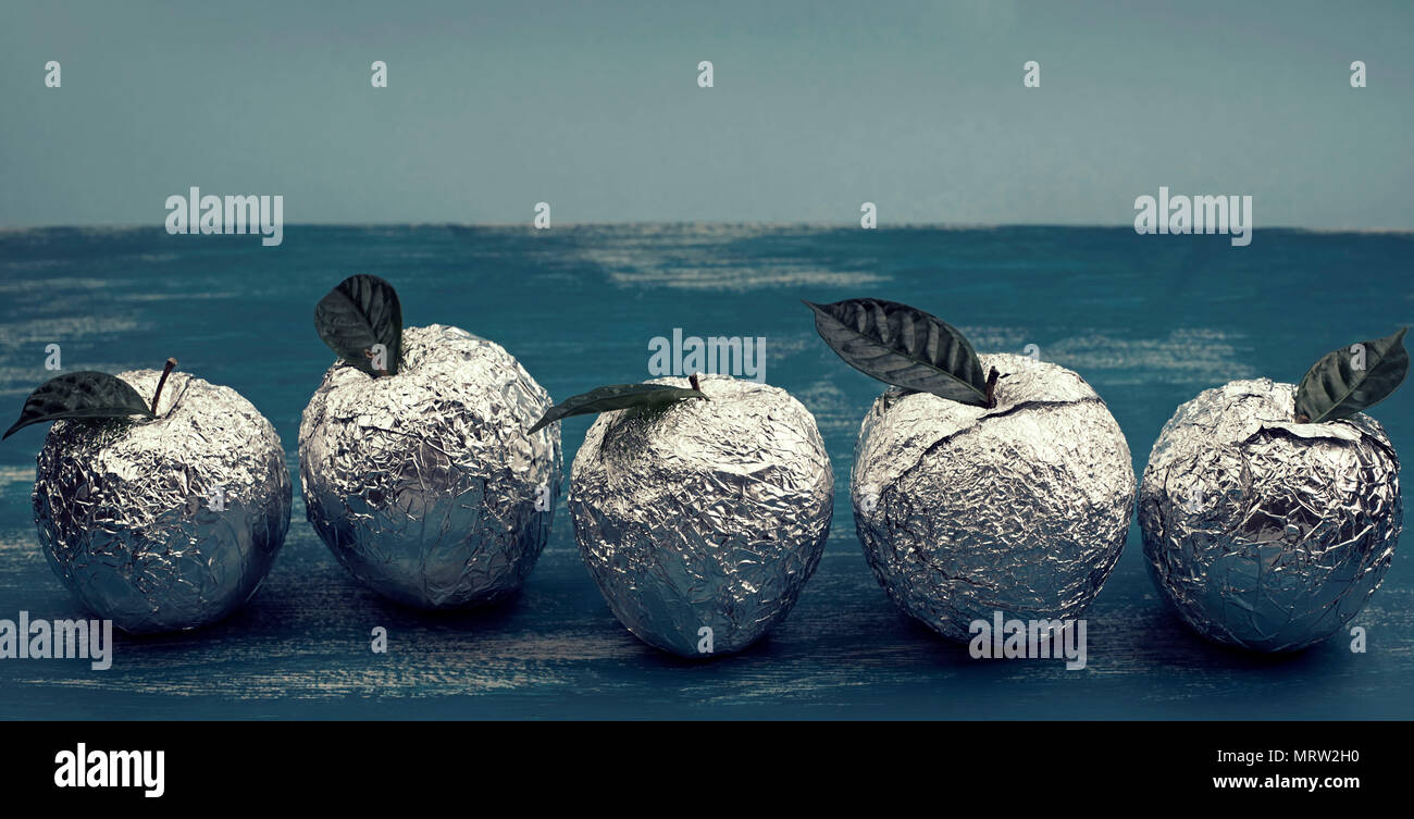 Banner Five apples in the shell foil with natural green leaves. Wooden ...
