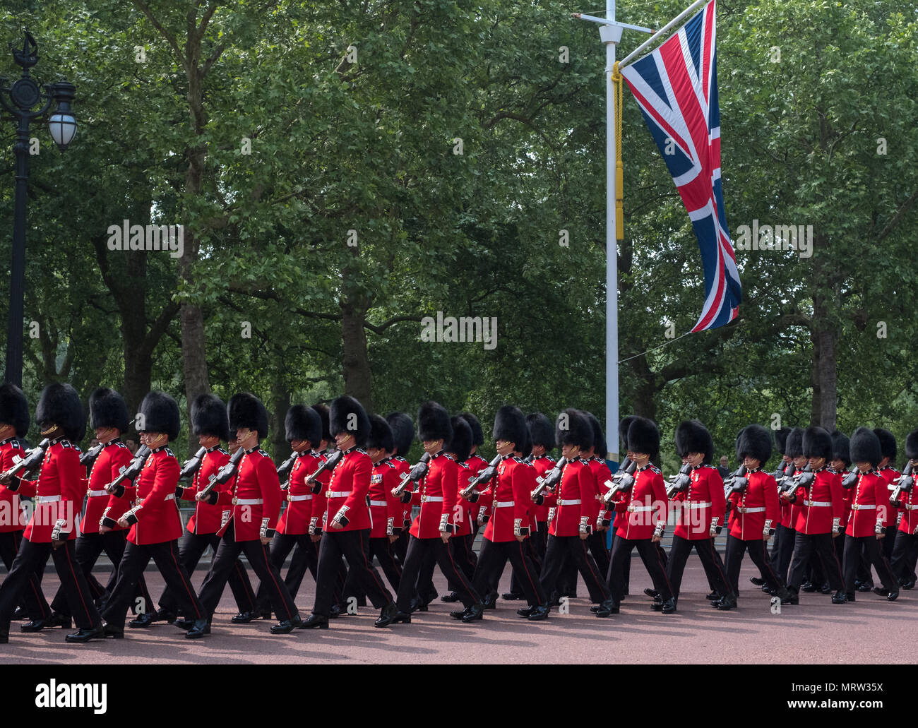 Soldiers with rifles marching down The Mall in London UK. Photo taken ...