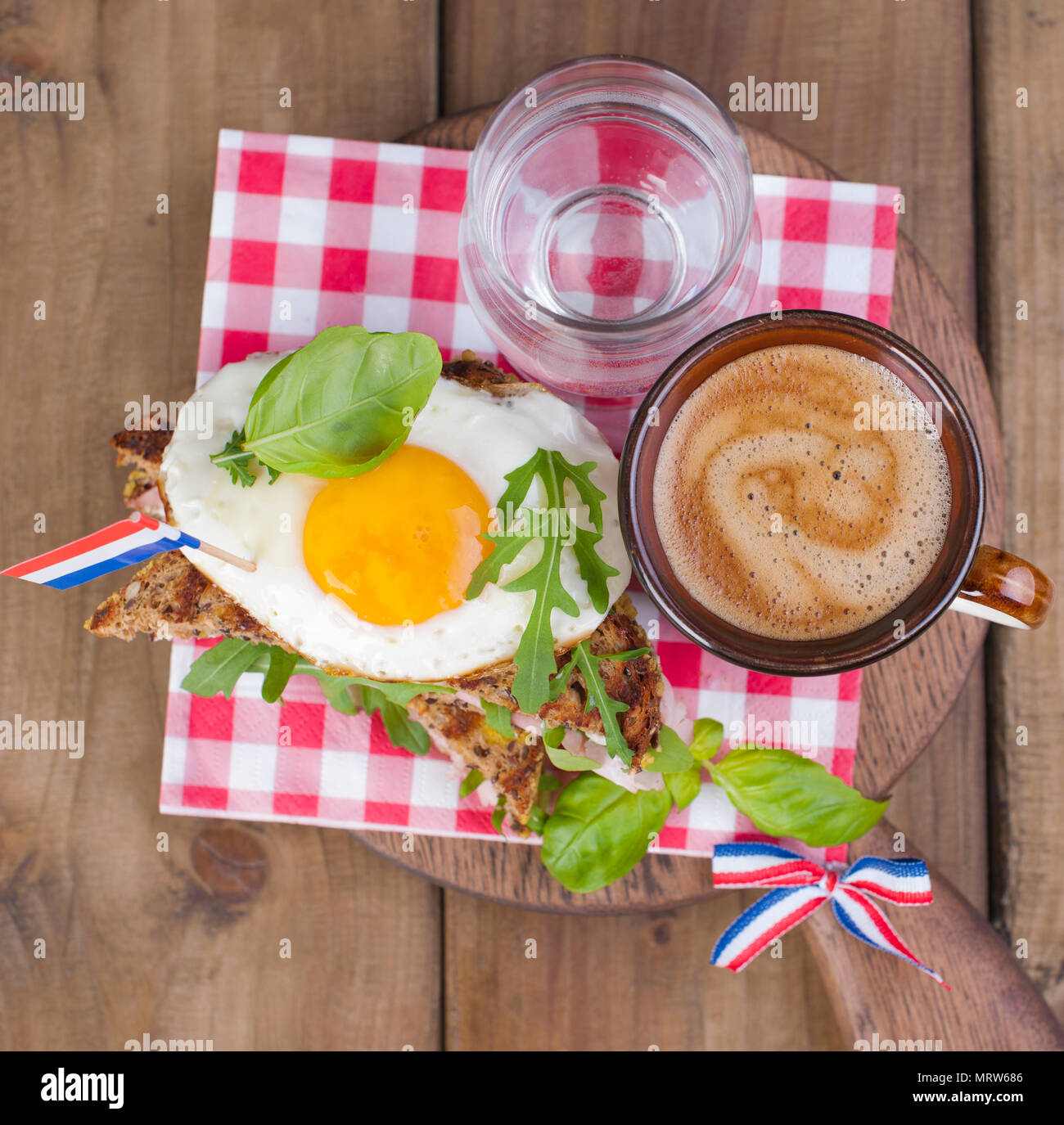 Breakfast with coffee, toasts, butter and jam on wooden background ...