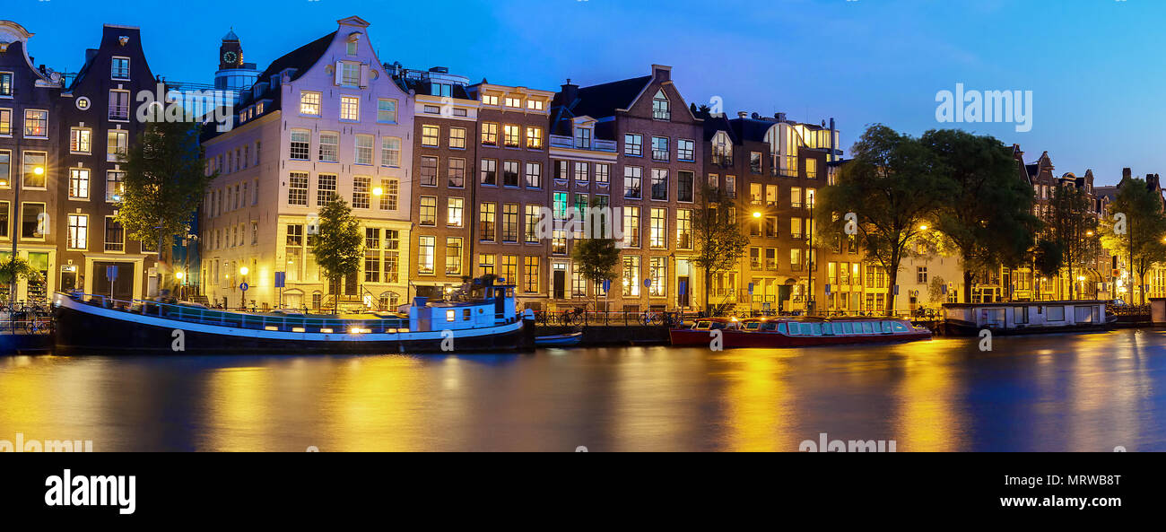 Night panoramic city view of Amsterdam canal, typical dutch houses and ...