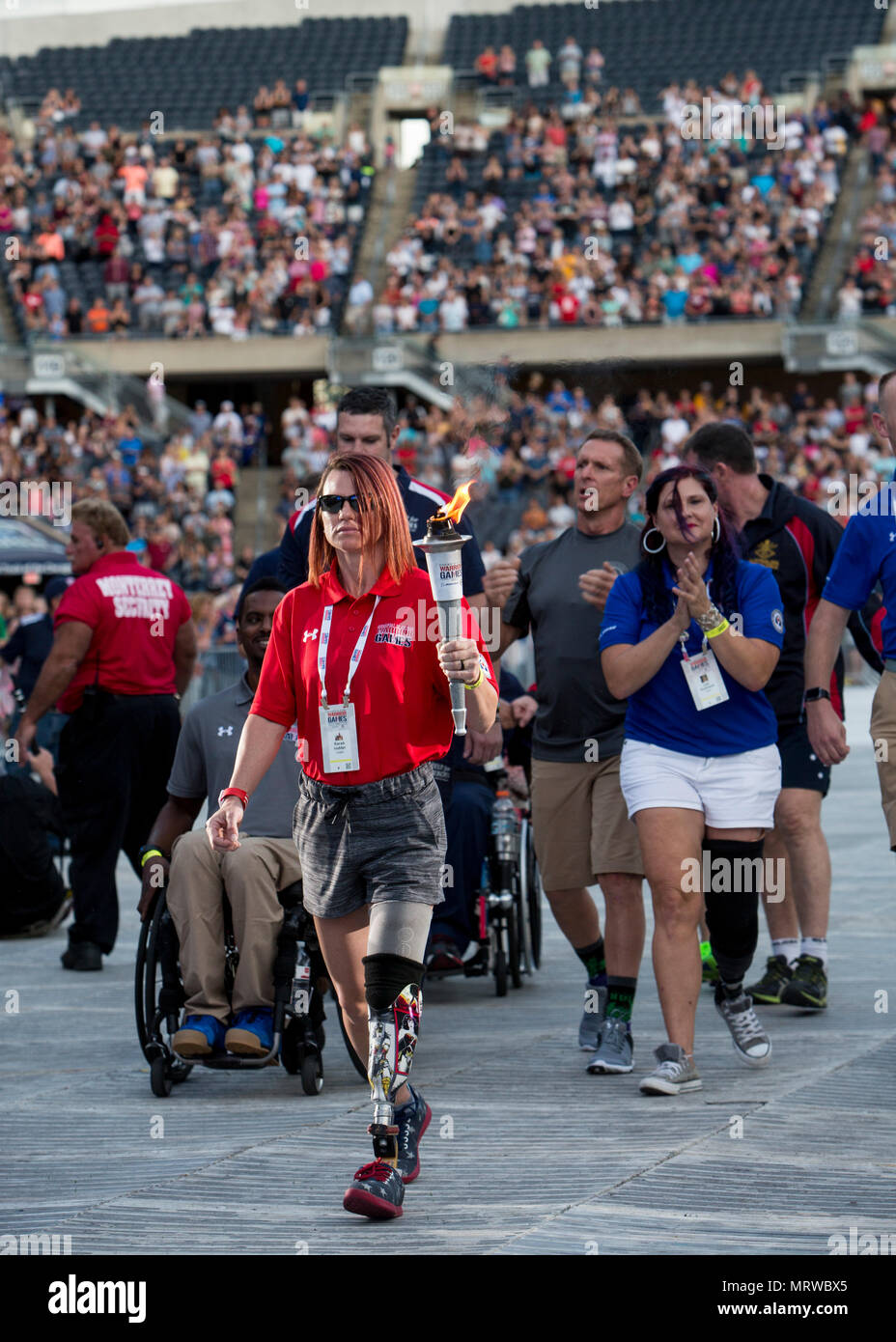 U.S. Marine Corps veteran Sarah Rudder carries the 2017 DoD Warrior ...