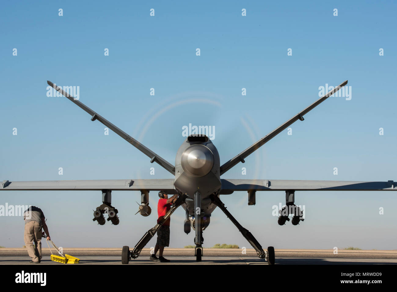 Maintainers perform final preflight procedures prior to a MQ-9 Reaper ...