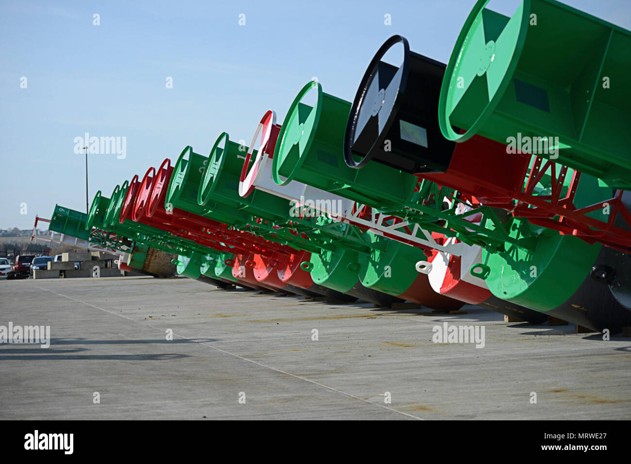 Recently painted aids to navigation buoys lay ready to be deployed as ...