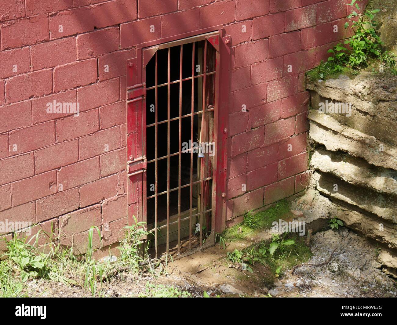 A secret backdoor locked with grills in the basement floor of a ...