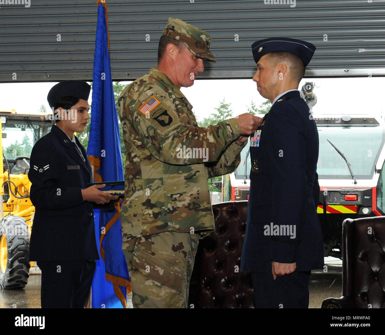 Col. Daniel Morgan, JBLM Joint Base Garrison Commander, left, presents ...