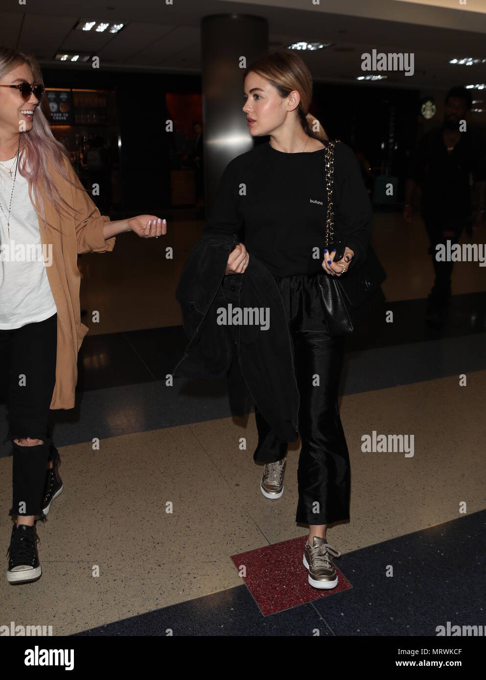 Lucy Hale arrives at the airport carrying a black Chanel handbag ...