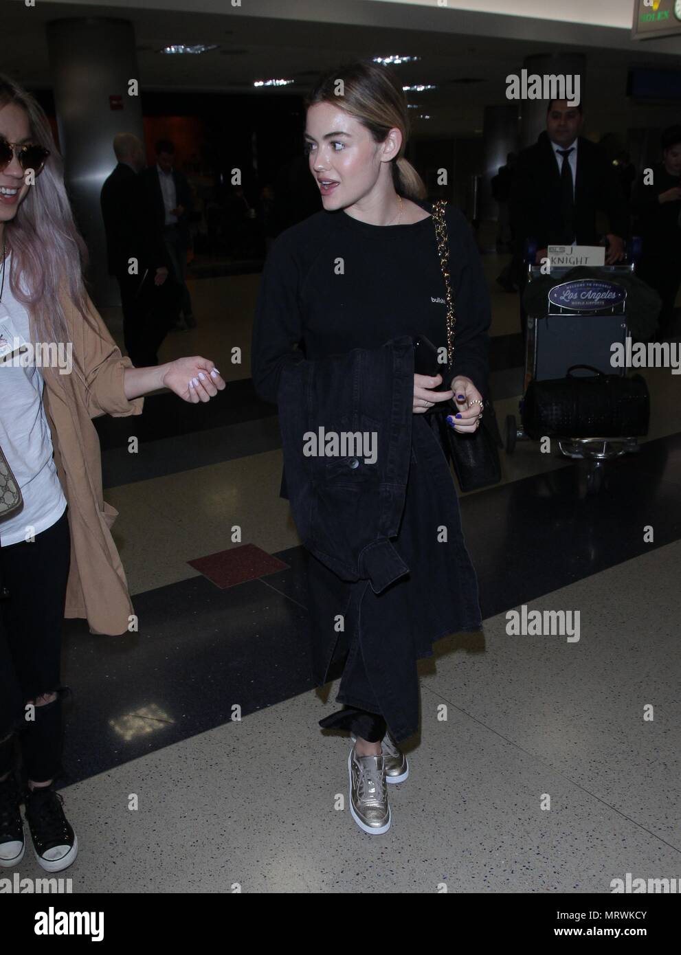 Lucy Hale arrives at the airport carrying a black Chanel handbag ...