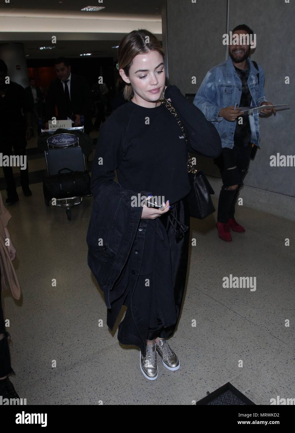 Lucy Hale arrives at the airport carrying a black Chanel handbag ...
