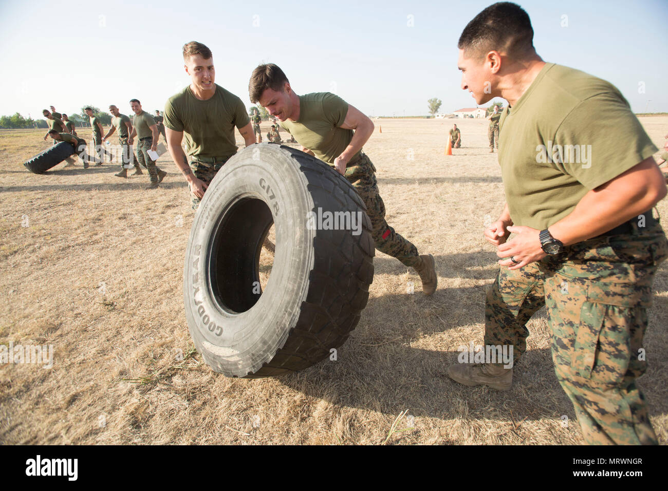 Sergeant Nicholas Wheeler, center, is encouraged by Cpls. Julio Robles ...