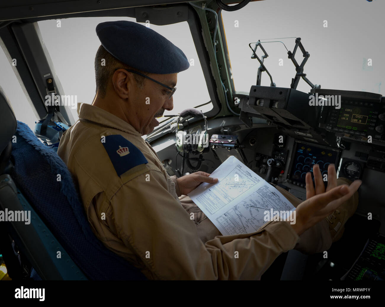 A Qatar Emiri Air Force pilot reviews a mission plan during the loading ...
