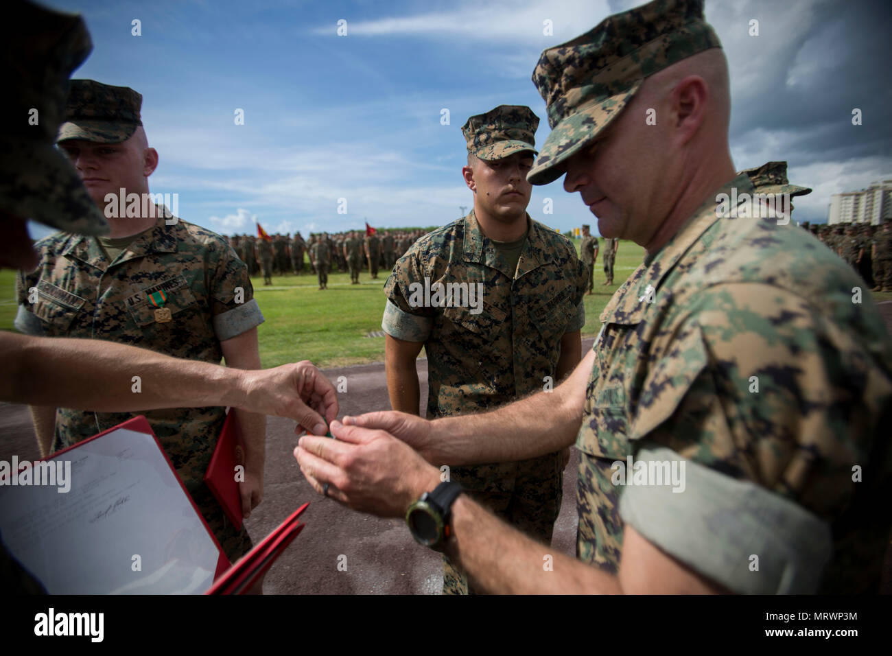 U.S. Marine Cpl. Otto Thiele receives a Navy Acheivement Medal from Col ...