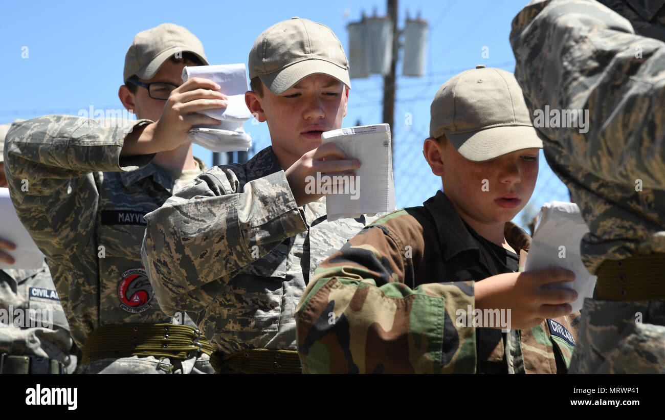 Civil Air Patrol (CAP) Cadets review their "smart books" while standing ...