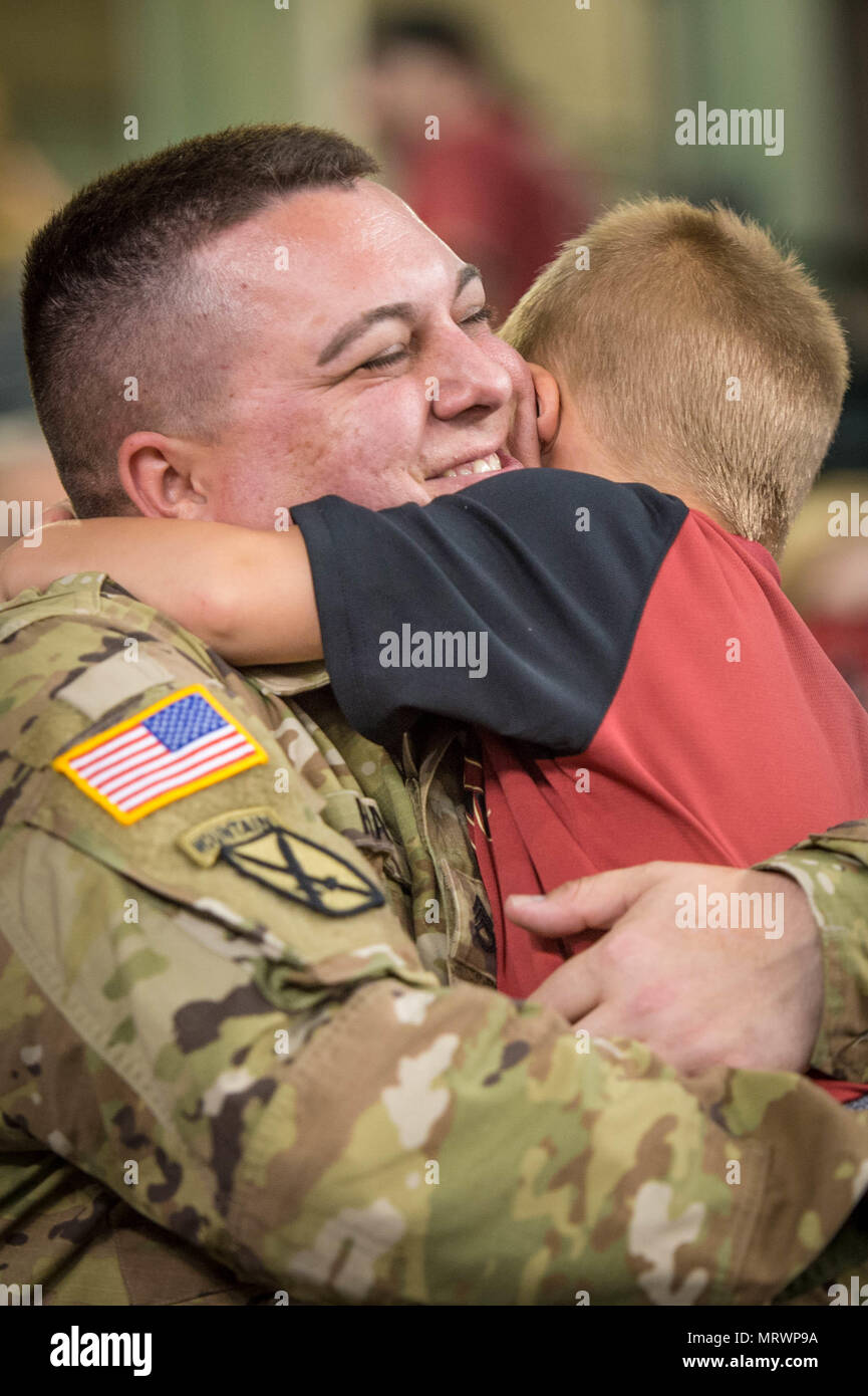 U.S. Army Staff Sergeant Matthew Hart, 305th MI Battalion, hugs his son ...