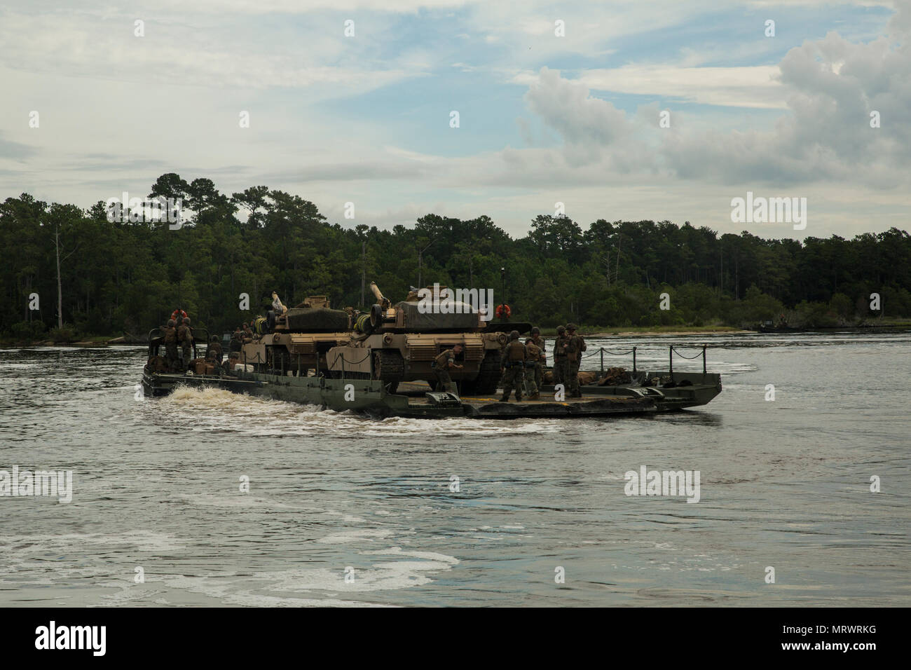 Marines begin crossing a river on a seven-bay raft system with two M1A1 ...
