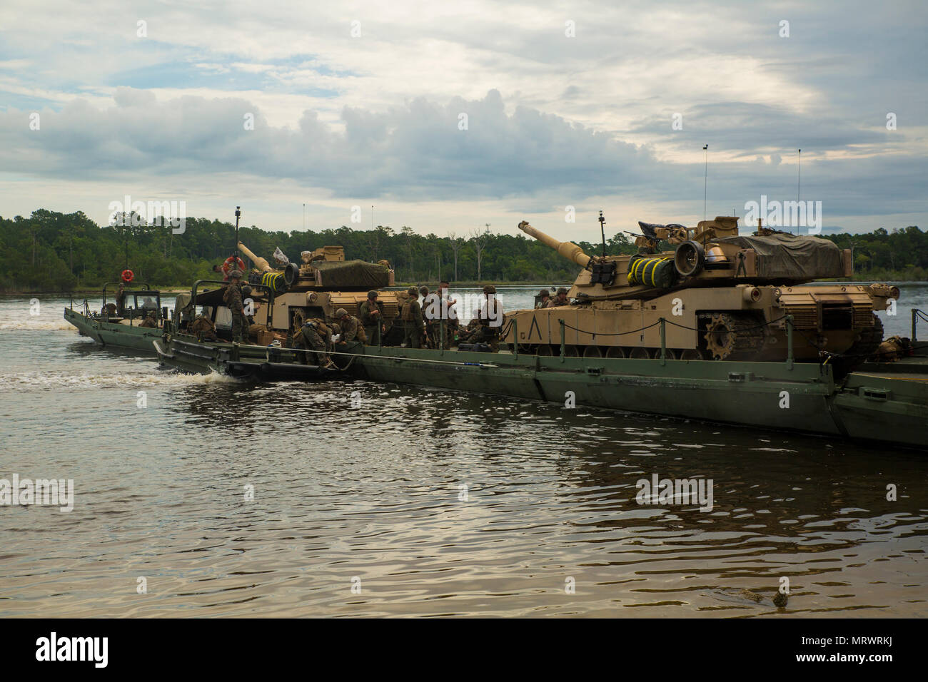 Marines pull away from shore on a seven-bay raft system after loading ...