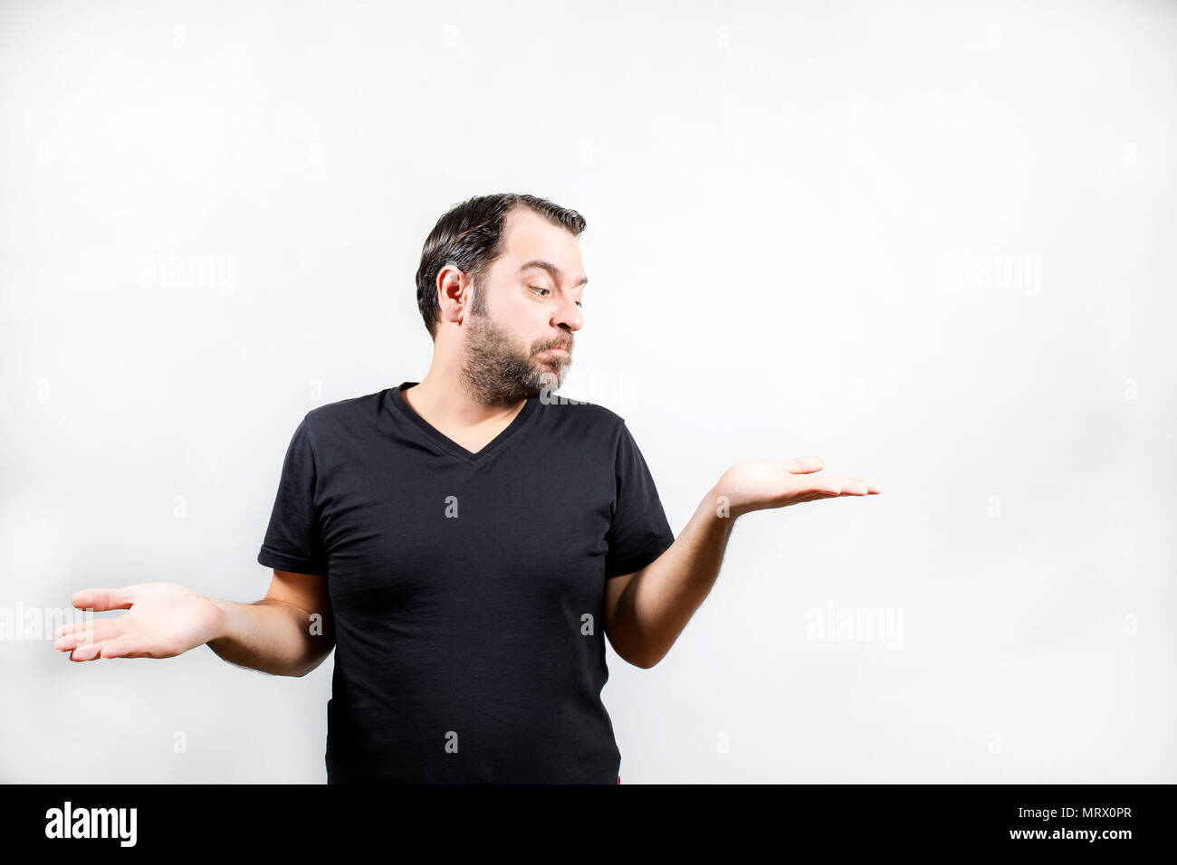 Adult man is comparing things on his hand and can't decide Stock Photo ...