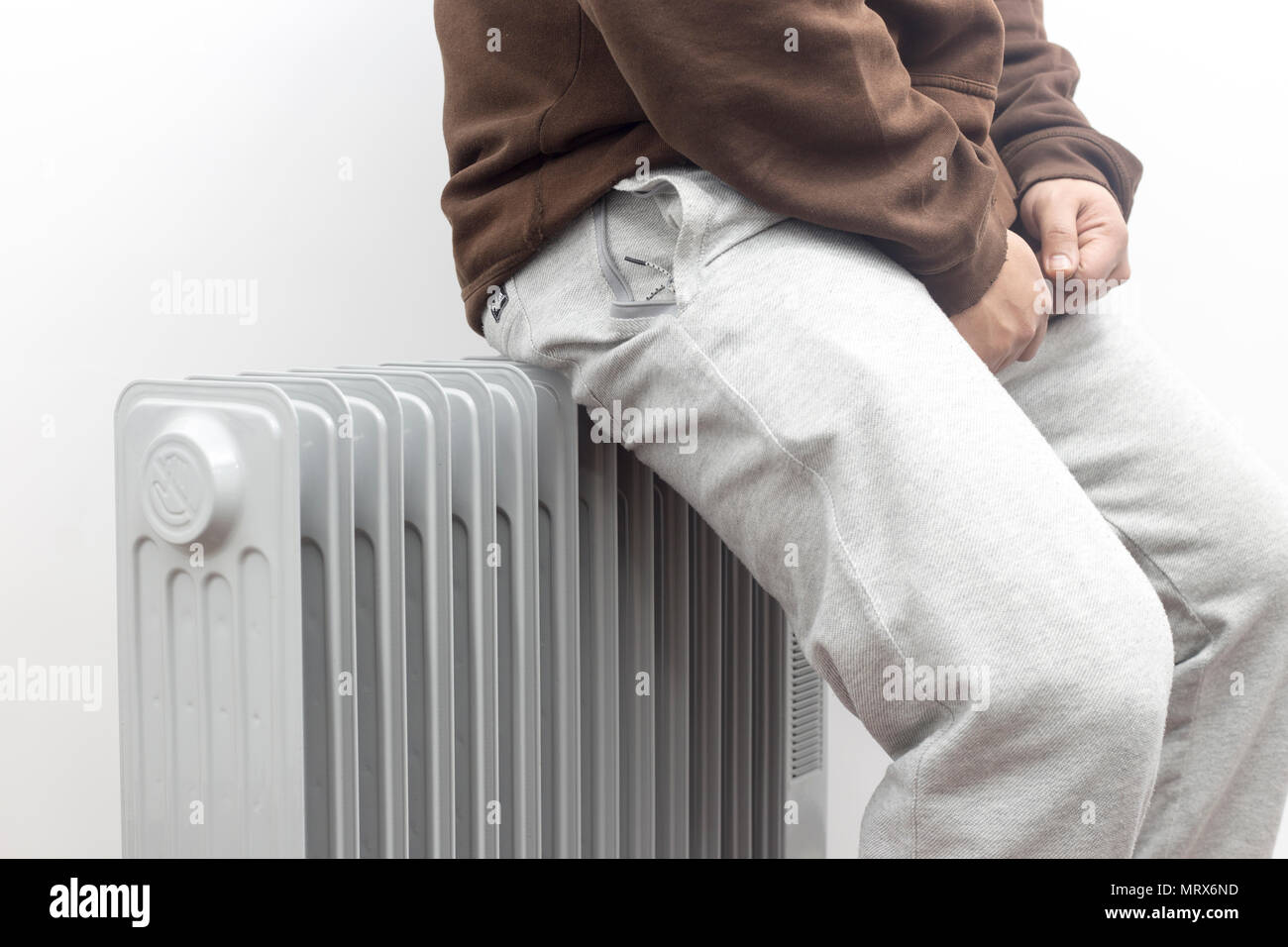 Man sitting on heater hi-res stock photography and images - Alamy