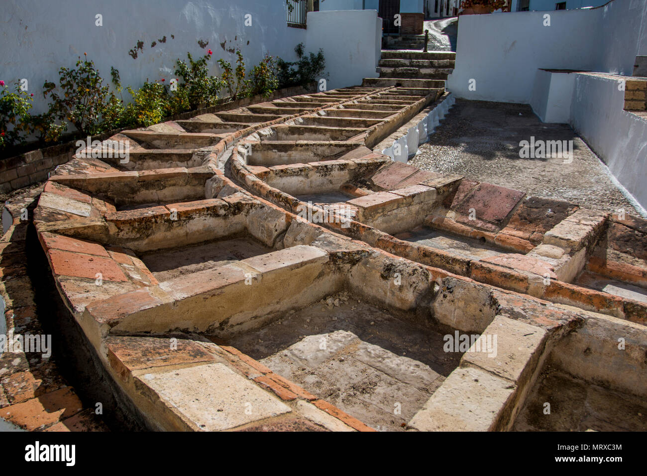 Exterior view of ancient stone cells arranged in backyard in bright ...