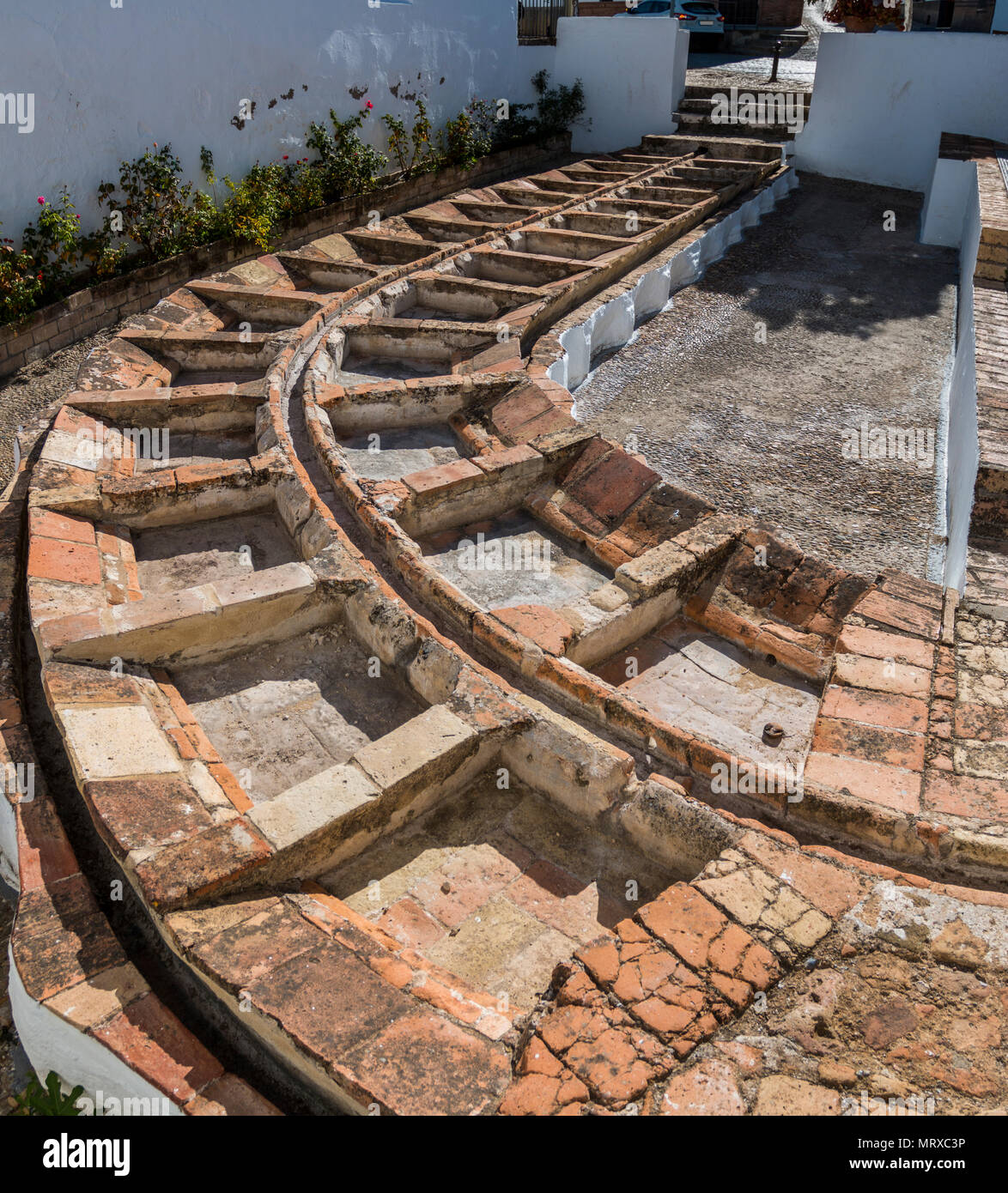 Exterior view of ancient stone cells arranged in backyard in bright ...