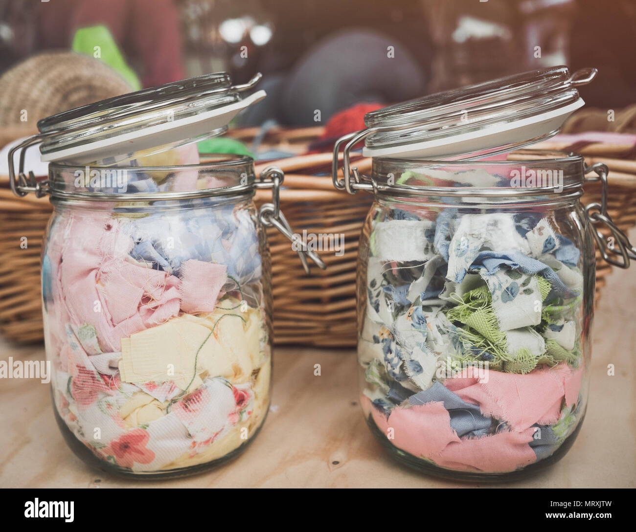 two open glass jars full of scraps fabric Stock Photo - Alamy