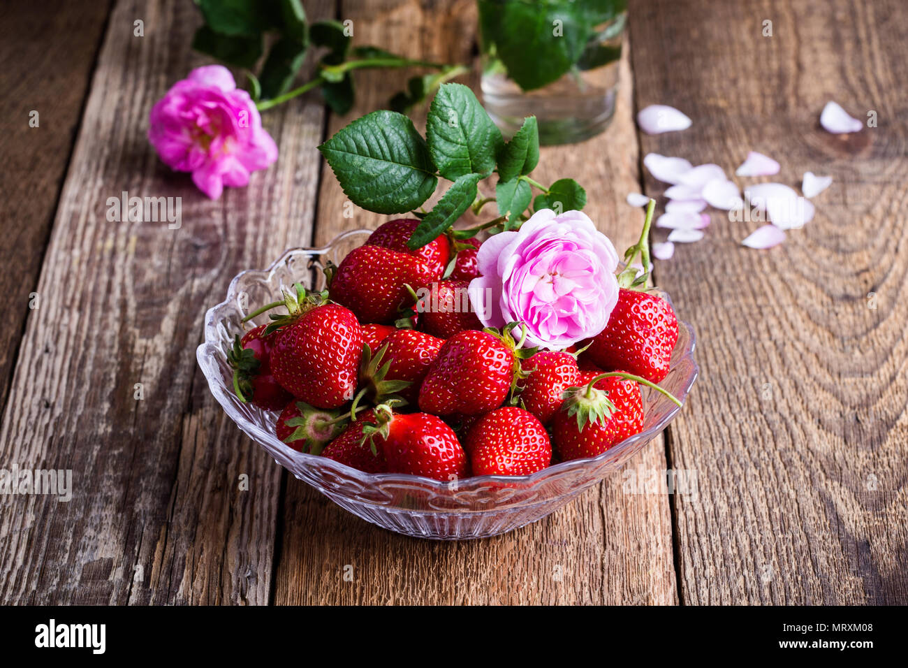 Strawberry in glass bowl on rustic wooden table, still life with ...