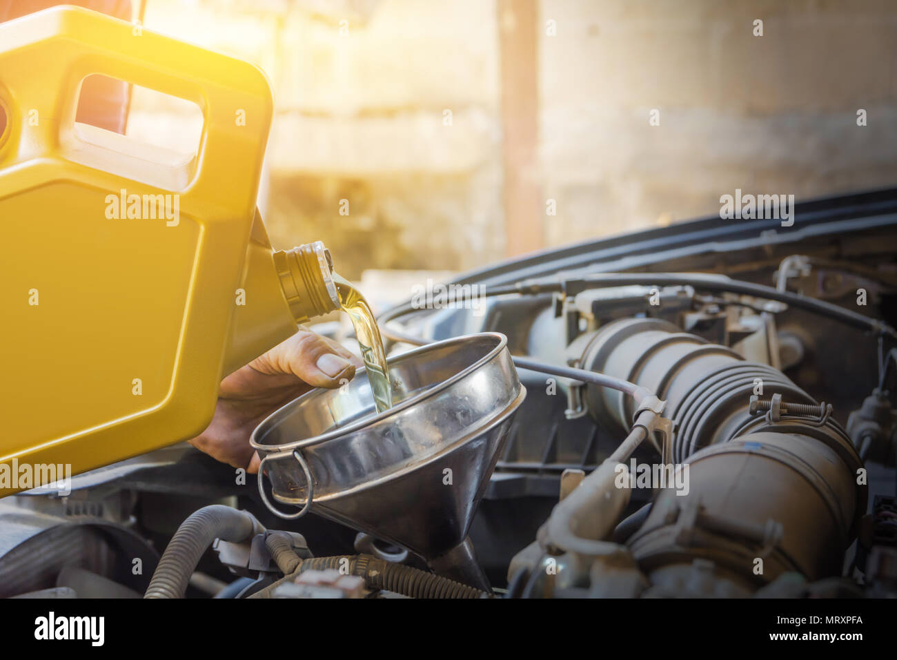 Technician checking engine and refueling. Auto mechanic checking car ...