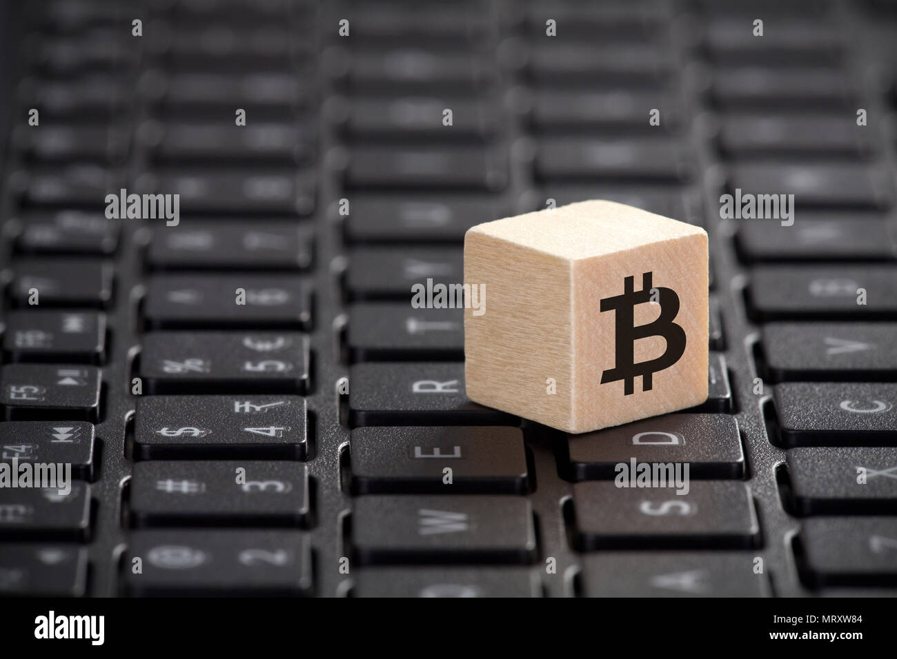 Wooden block with bitcoin graphic on laptop keyboard Stock Photo - Alamy