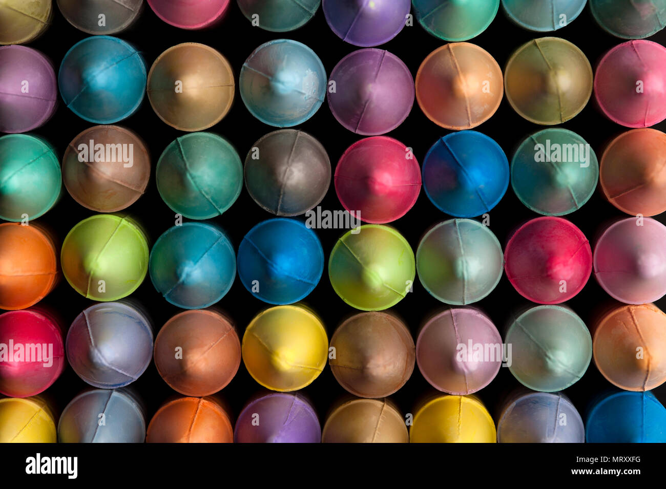 Multicolored colored chalk in rows creating interesting color patterns ...