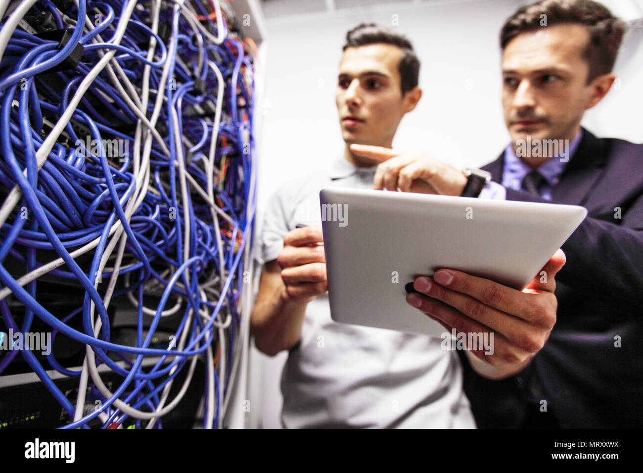 Manager teaching young technician hi-res stock photography and images ...