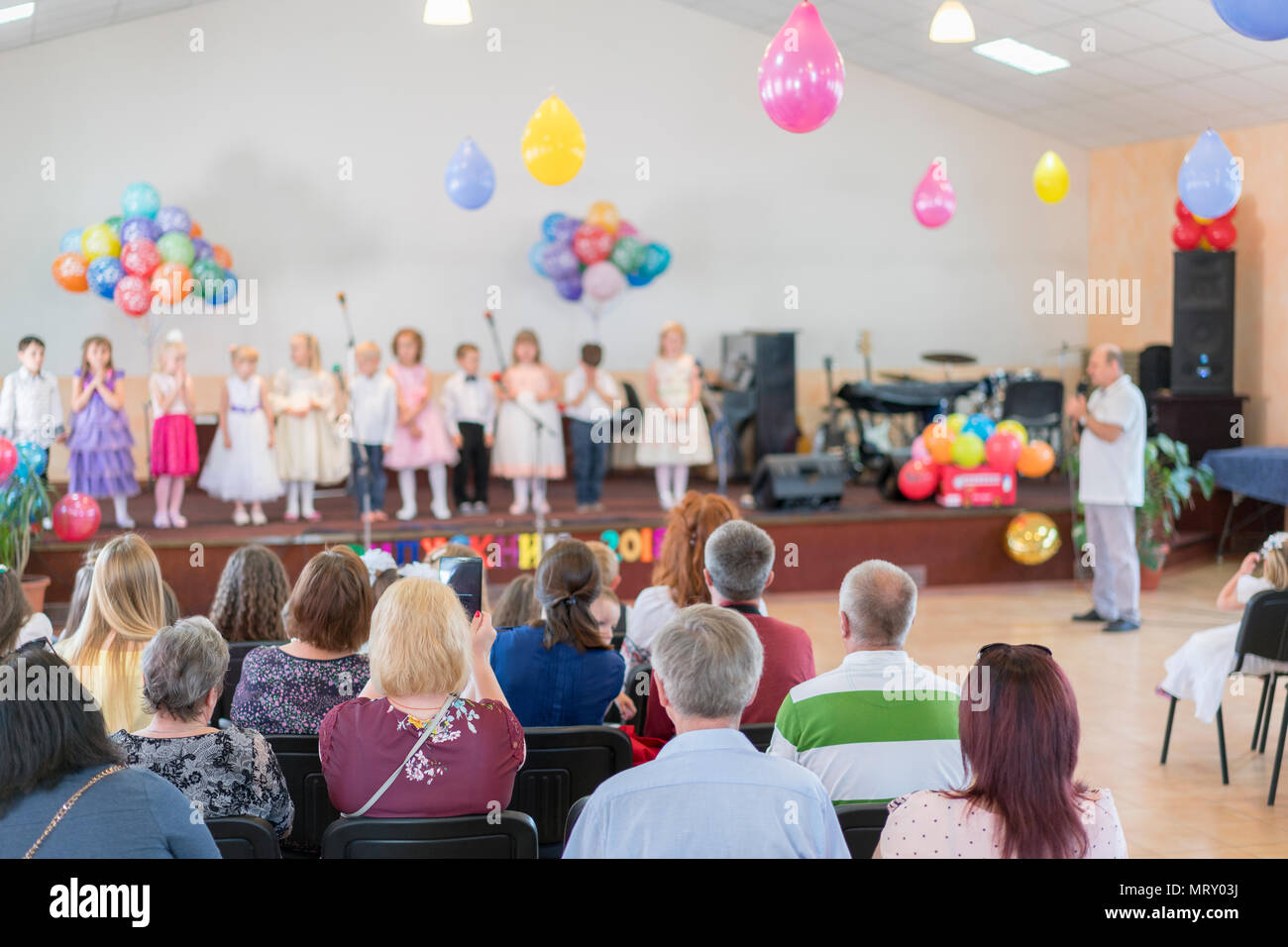 Children's holiday in kindergarten. Children on stage perform in front ...
