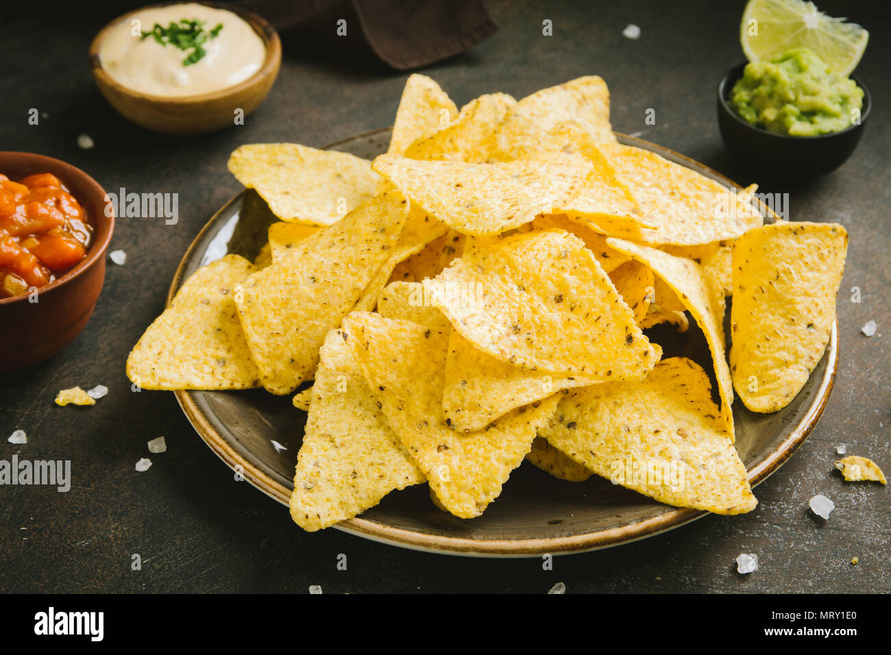 Nachos chips and various dip sauces, close up. Tortilla corn nachos ...