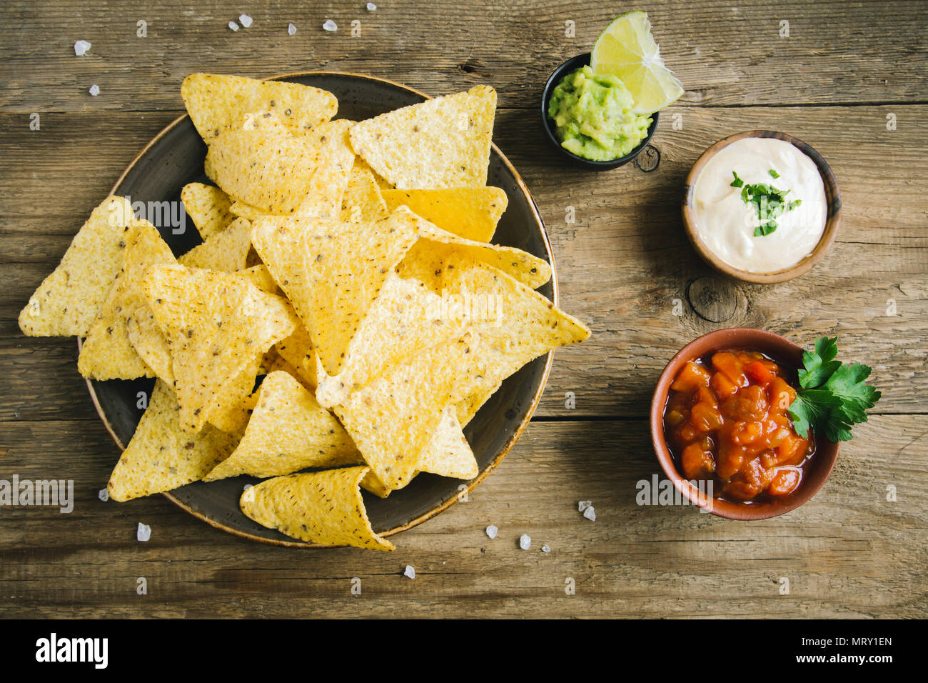 Nachos chips and various dip sauces, close up. Tortilla corn nachos ...