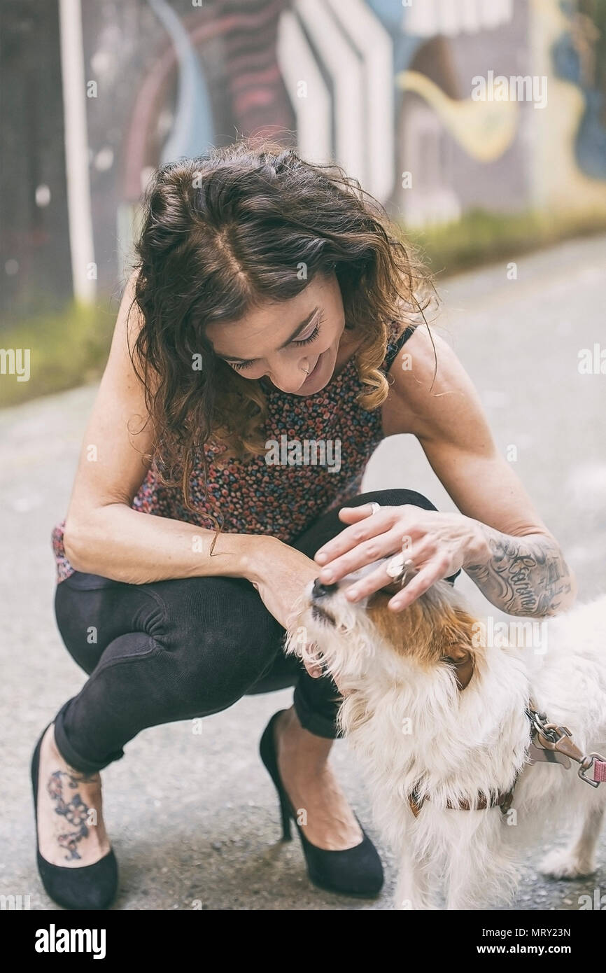 woman caressing a puppy Stock Photo - Alamy