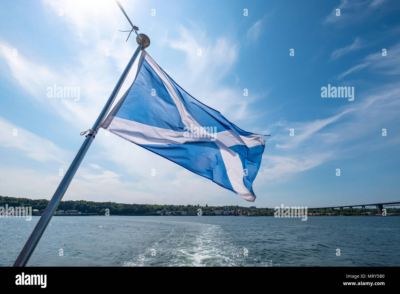 Scottish saltire flag flying from rear of ship on Firth of Forth river ...