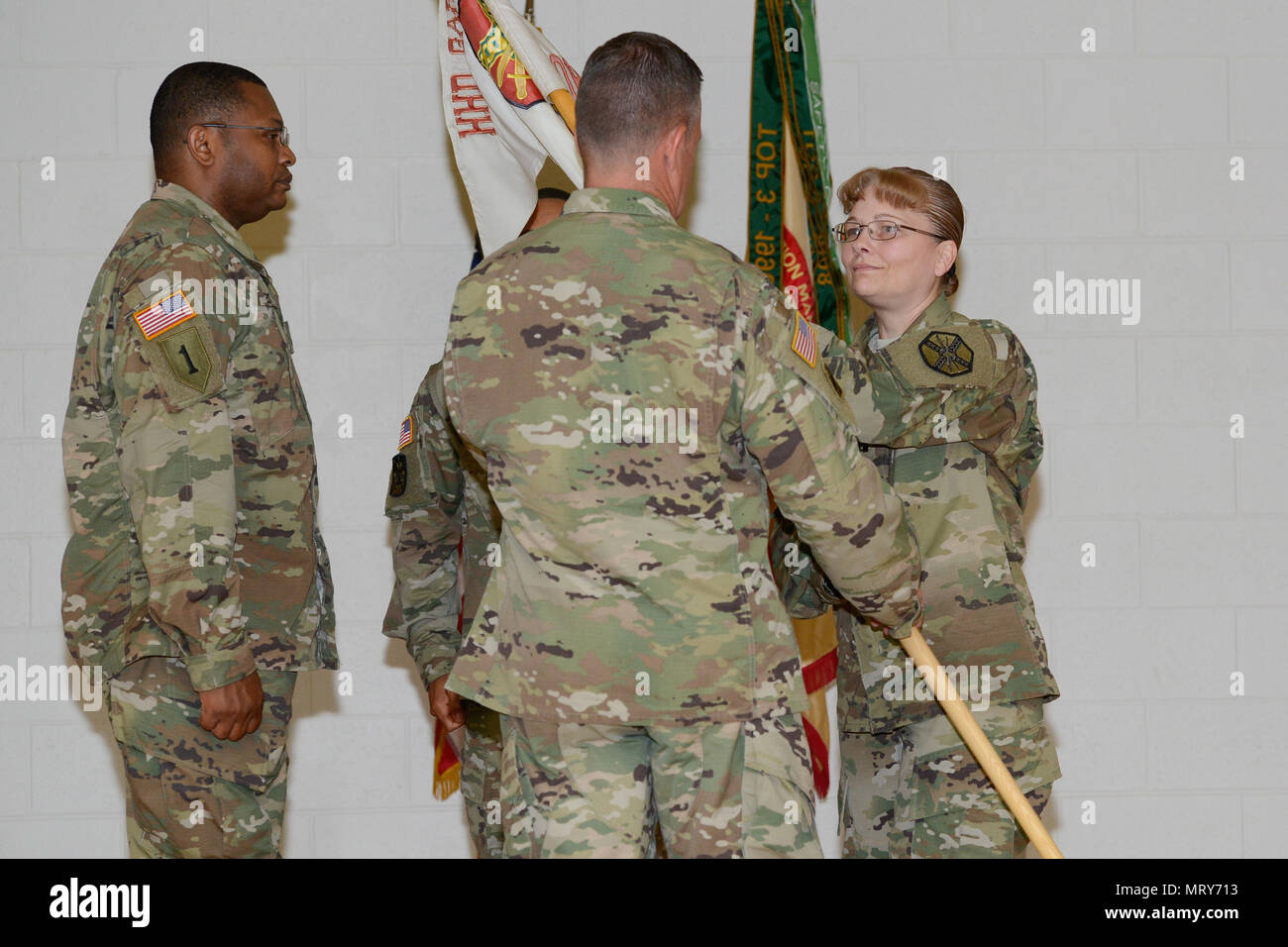 Outgoing Commander CPT Angela Reabold passes the guidon to COL Stephen ...