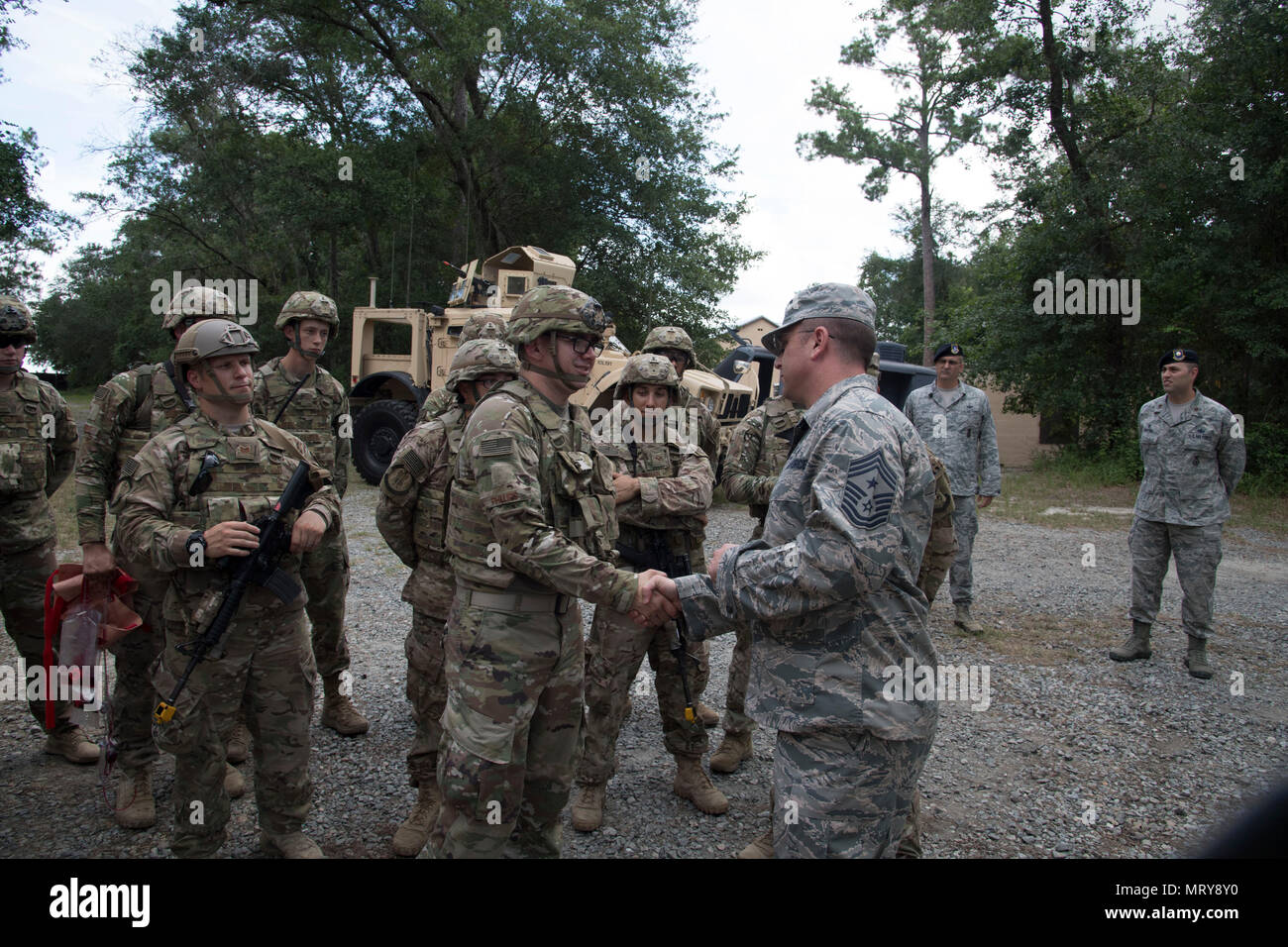 Chief Master Sgt. David Wade, 9th Air Force command chief, gives a coin ...