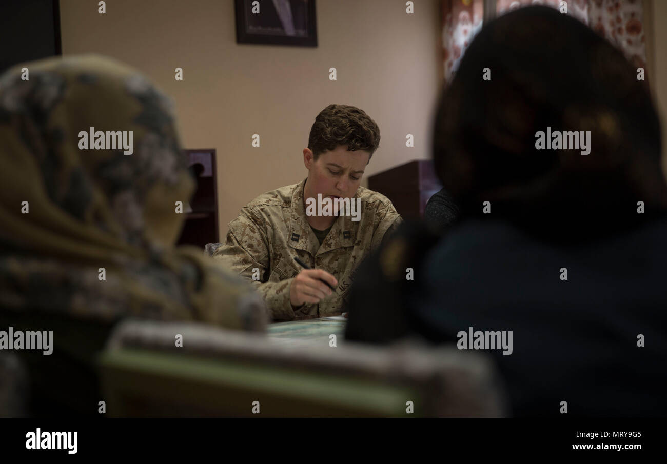 A U.S. Marine advisor with Task Force Southwest speaks with female ...