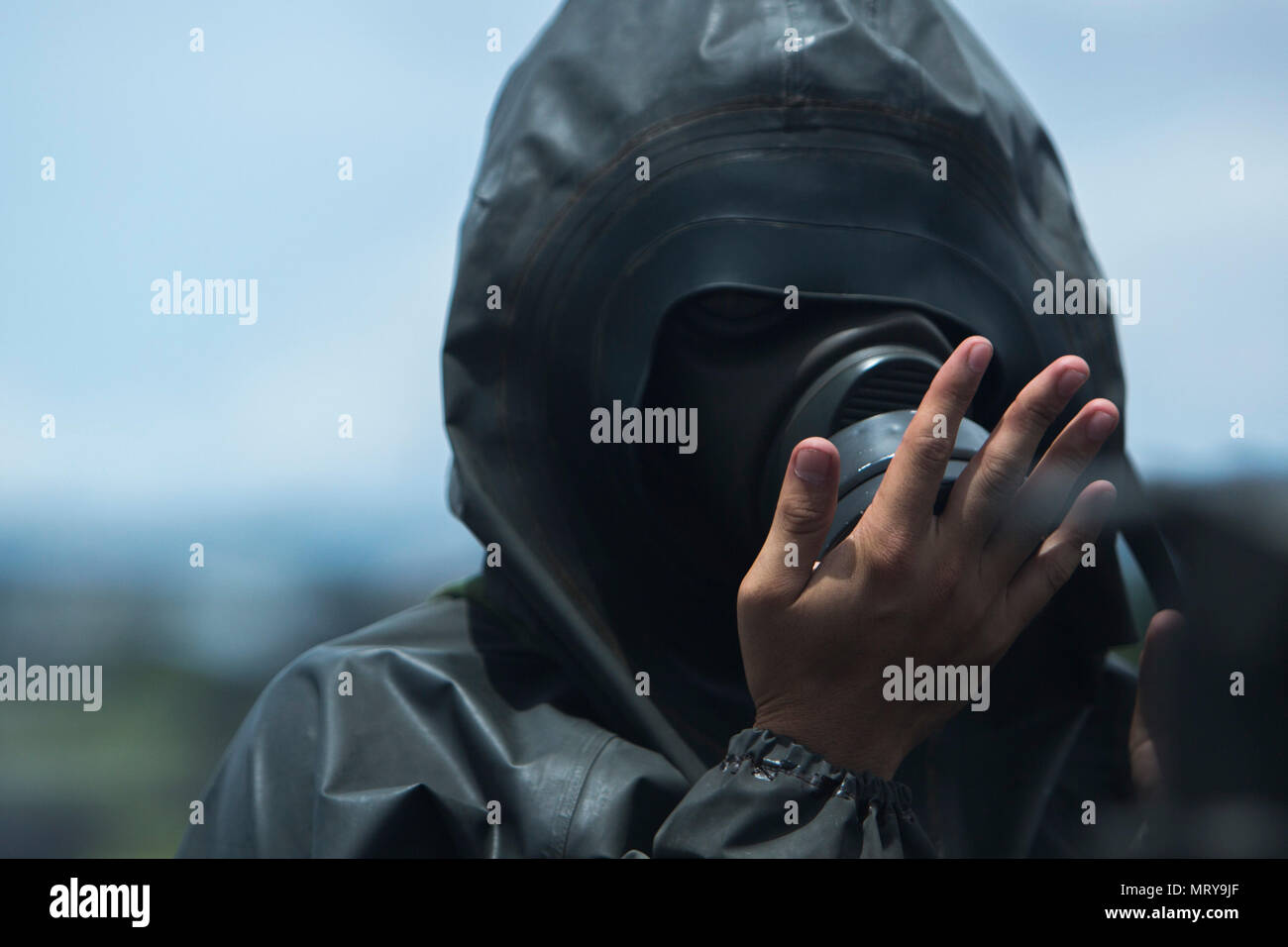A Japanese Ground Self-Defense service member clears his gas mask in ...