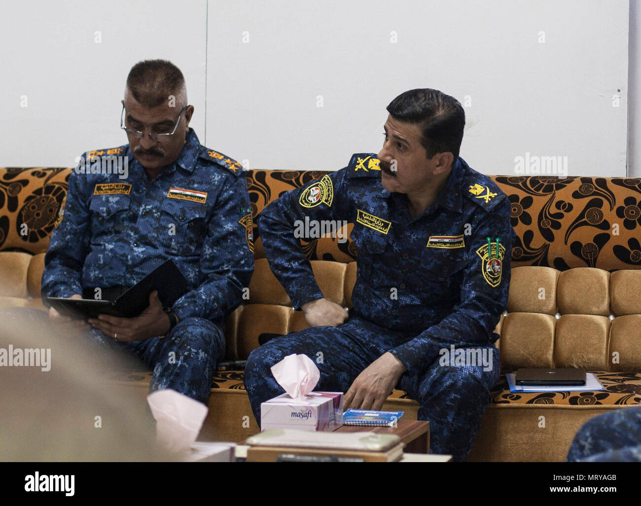Iraqi federal police members listen during an operational brief in ...