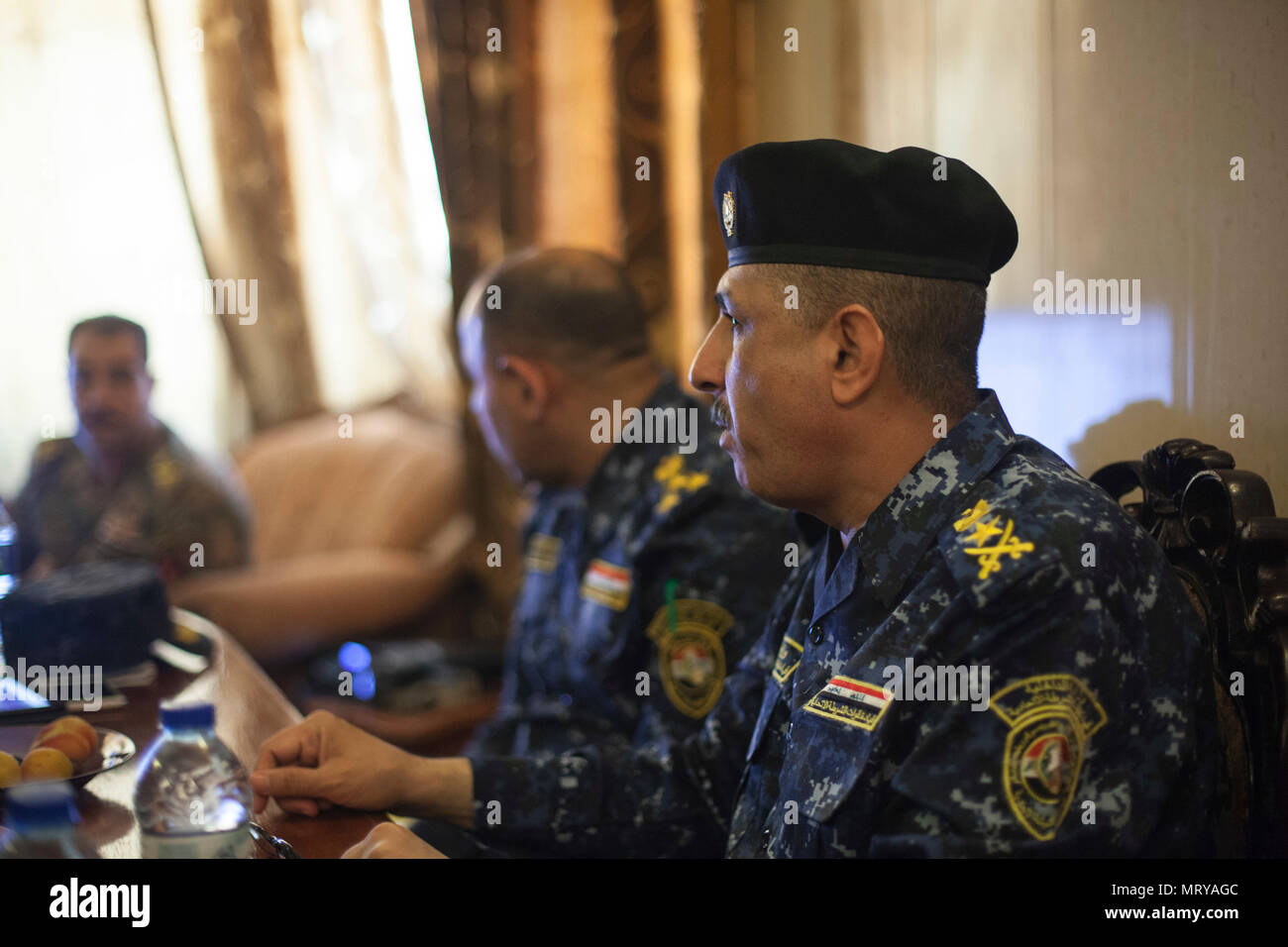 Iraqi federal police members speak with U.S. Army personnel during an ...